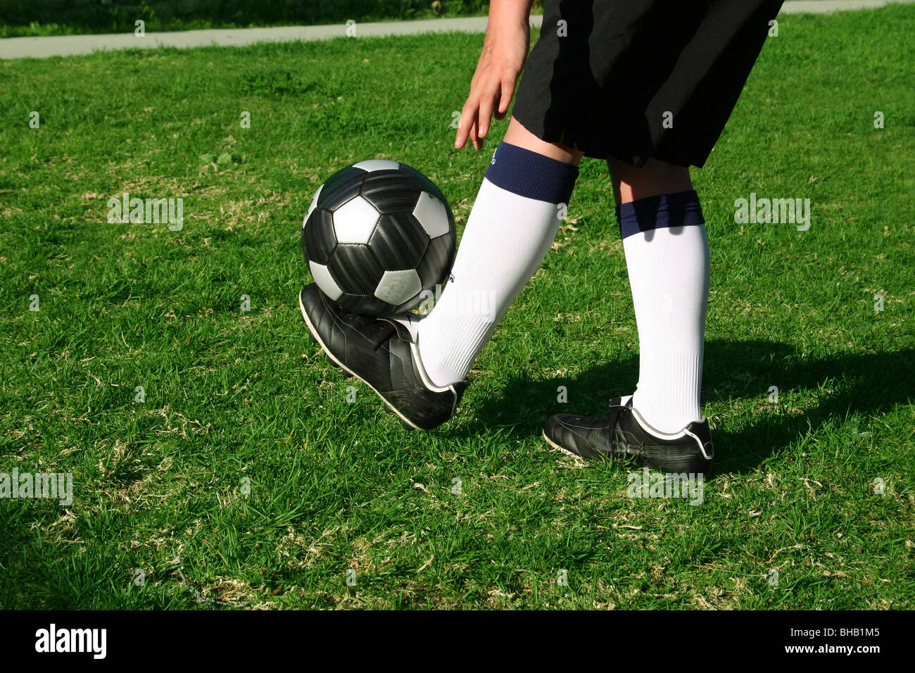 Fotball player practises his skills by balancing football on boot Stock ...