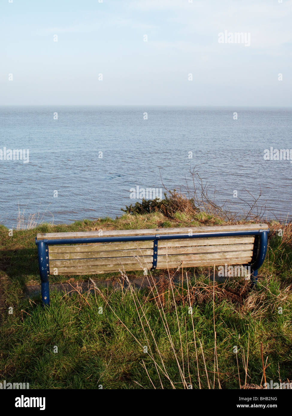 Wooden bench seat overlooking sea Stock Photo - Alamy
