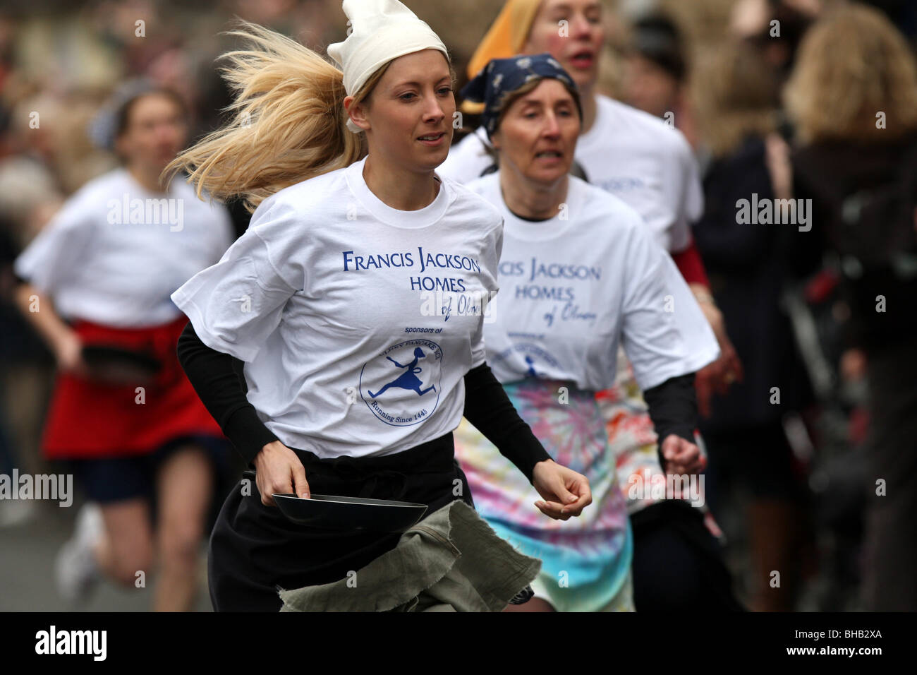 COMPETITORS IN THE WORLDS OLDEST PANCAKE RACE HELD IN OLNEY BUCKS Stock ...