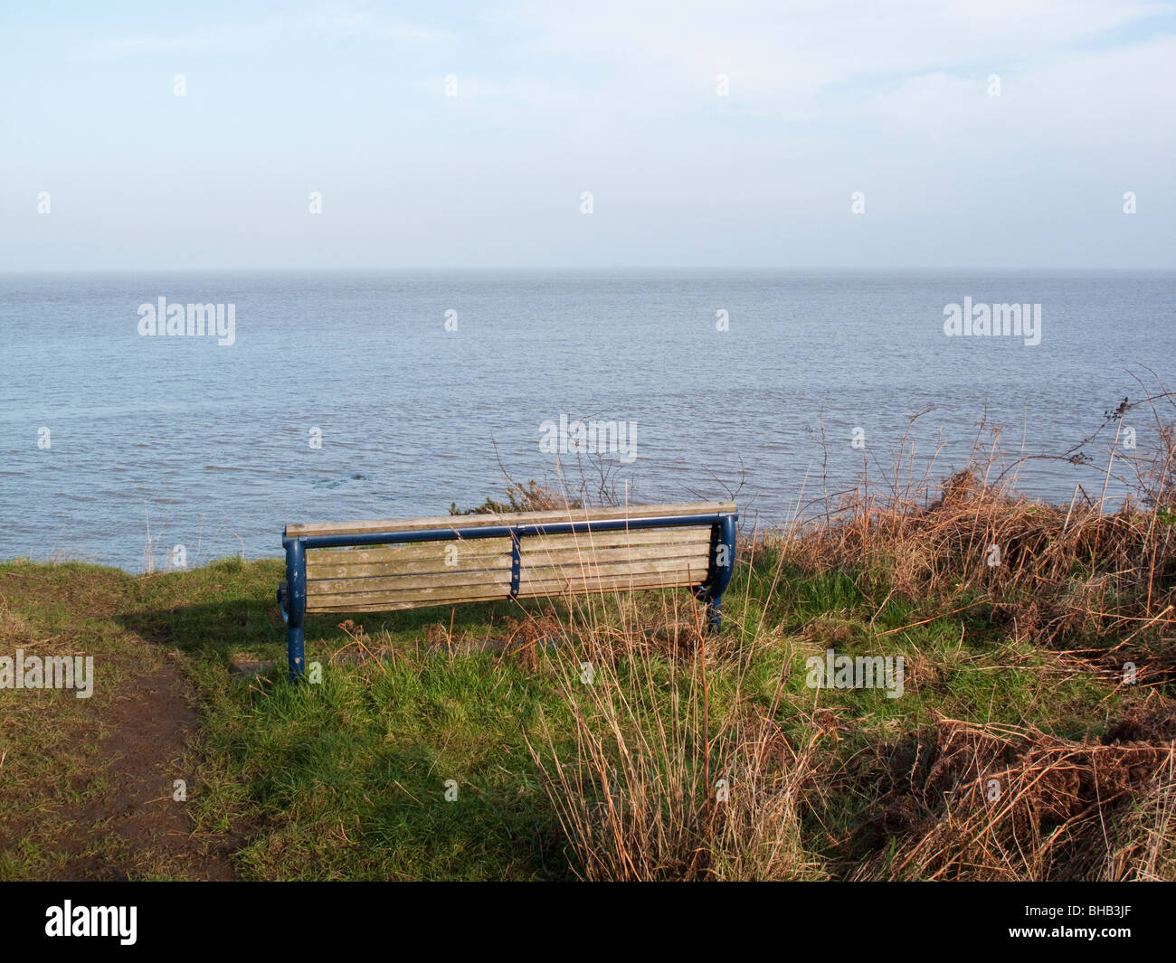Wooden bench seat overlooking sea Stock Photo - Alamy