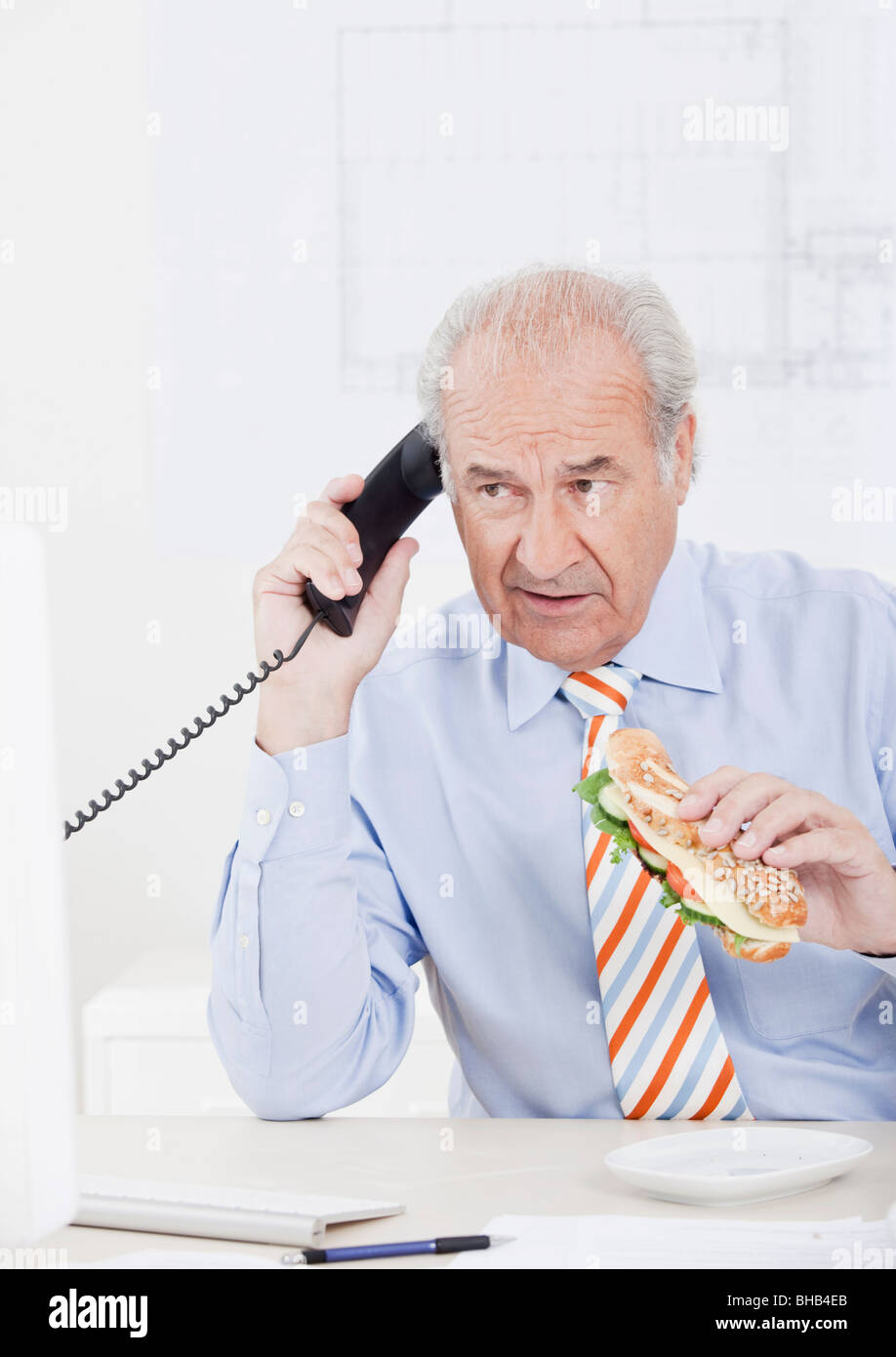 Eating at office desk man stress hi-res stock photography and images ...