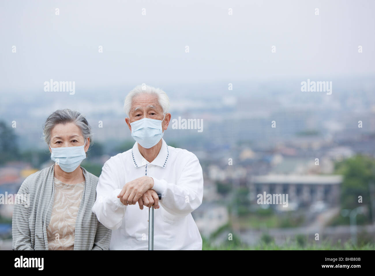 Japan, Tokyo Prefecture, Senior couple wearing flu mask, portrait Stock ...