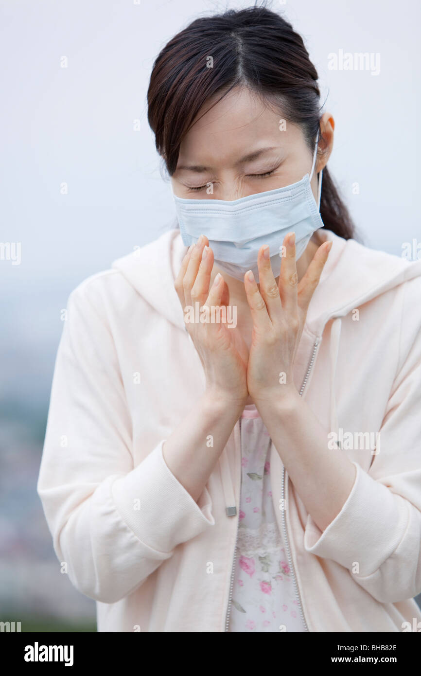 Japan, Tokyo Prefecture, Young woman wearing flu mask, close-up Stock ...