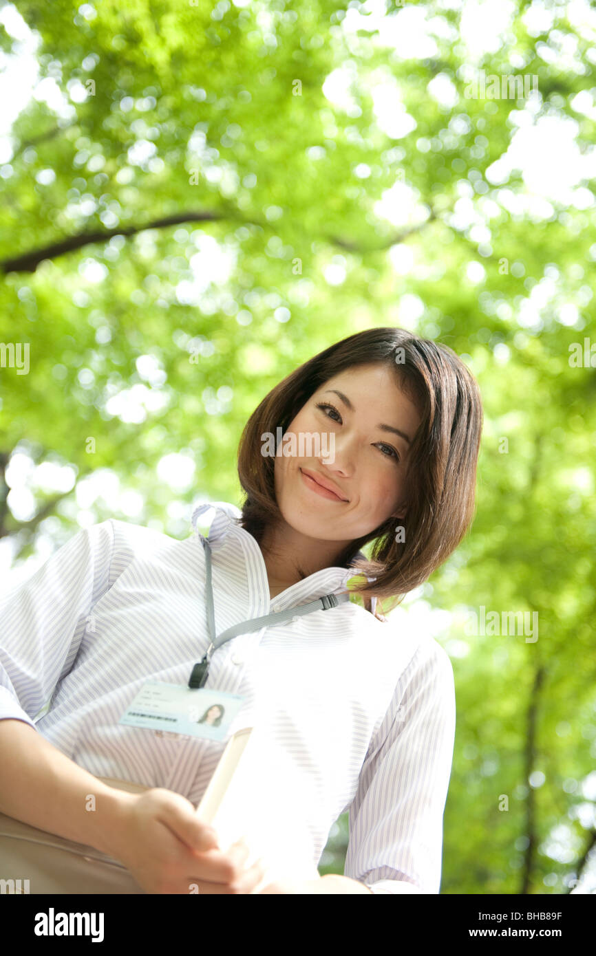 Japan, Osaka Prefecture, Businesswoman smiling, Portrait, low angle ...
