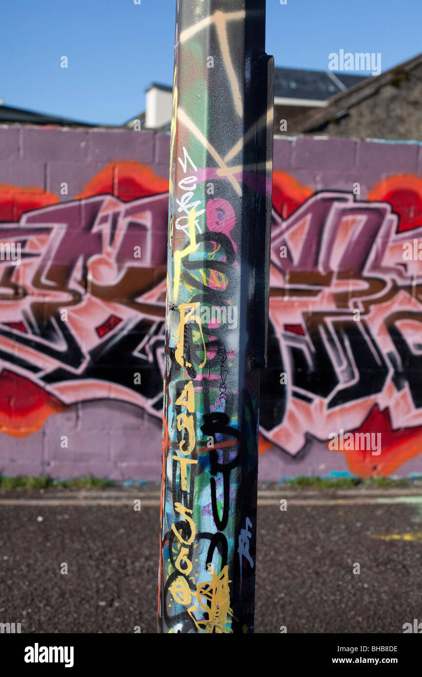 Street lamp spray painted in a graffiti park in an urban setting in a ...
