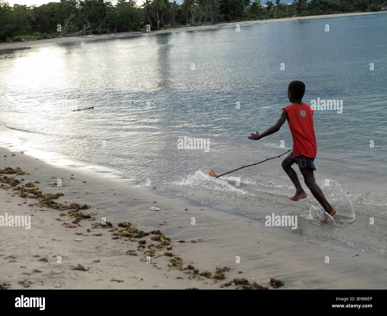 Madagascar, Africa. Mahambo. Boy playing on the beach Stock Photo - Alamy
