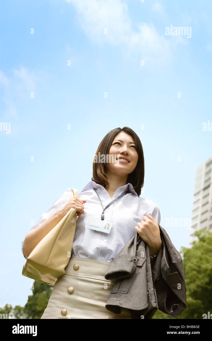 Japan, Osaka Prefecture, Businesswoman looking away, smiling Stock ...