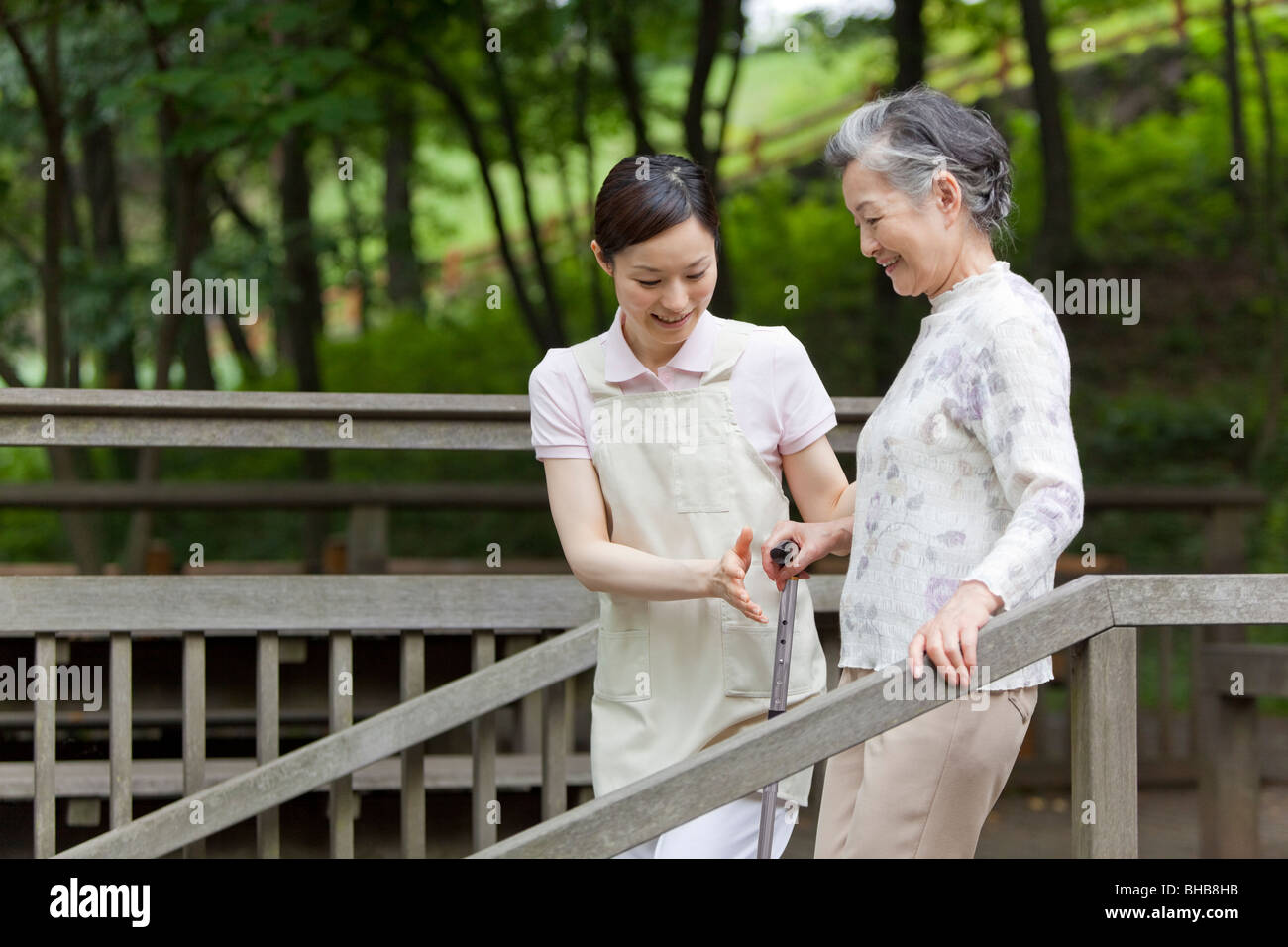 Japan, Tokyo Prefecture, Female nurse with senior woman standing on ...