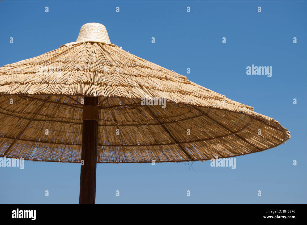 Straw beach umbrella Stock Photo - Alamy