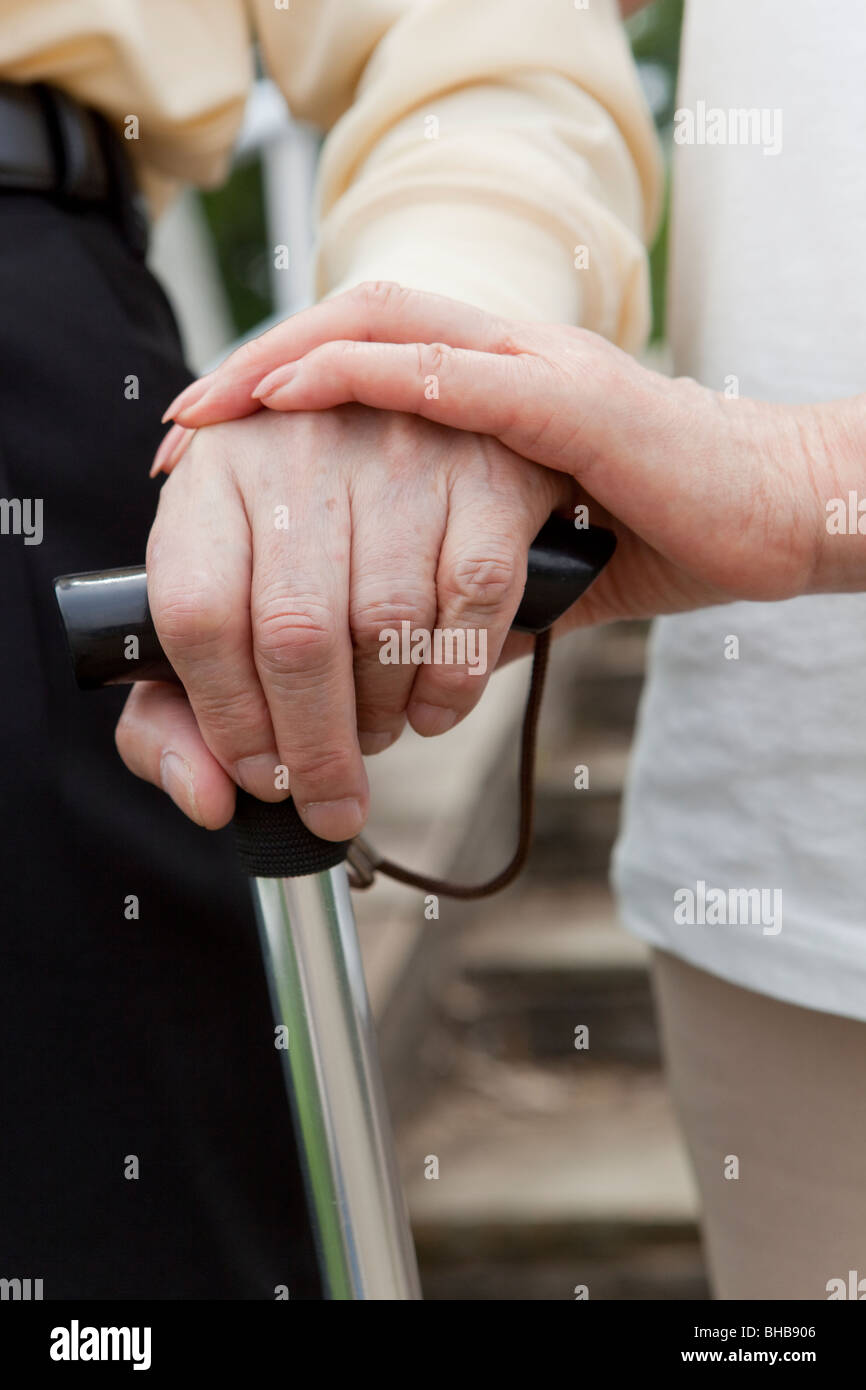 Japan, Tokyo Prefecture, Senior couple's hand holding walking stick ...