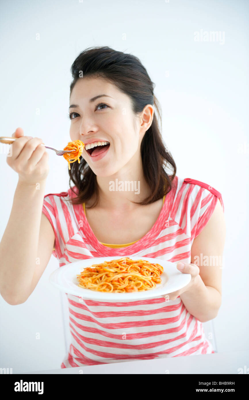Young woman holding plate spaghetti hi-res stock photography and images ...