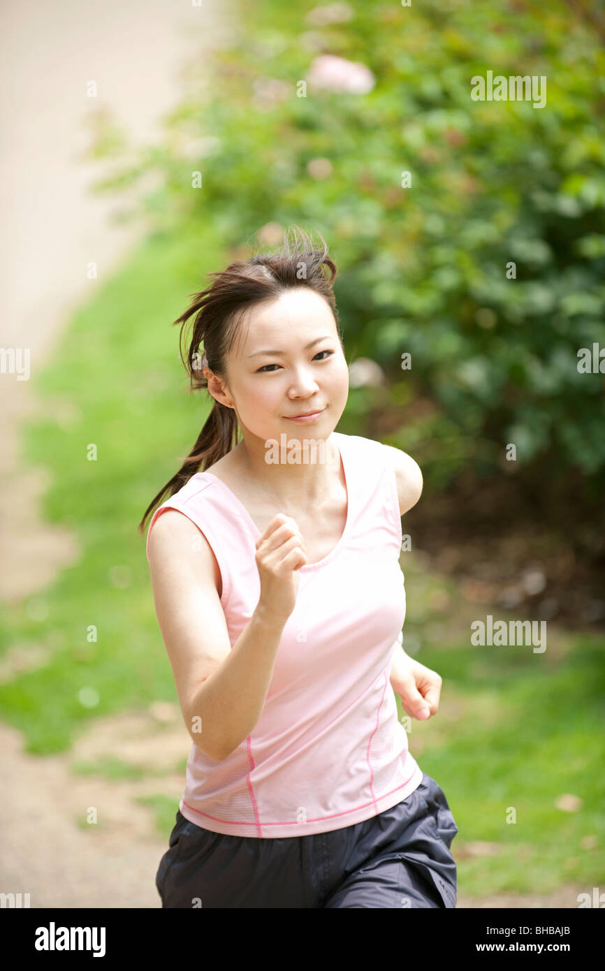 Japan, Osaka Prefecture, Mid adult woman running, front view Stock ...
