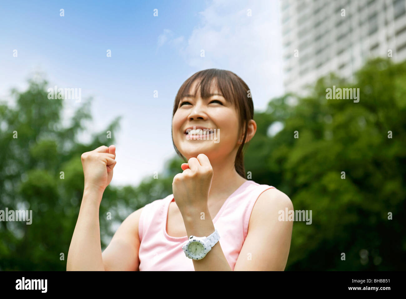 Japan, Osaka Prefecture, Woman cheering, smiling Stock Photo - Alamy
