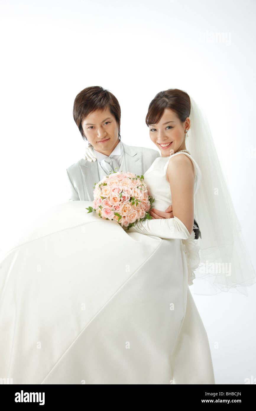 Bridegroom carrying bride hi-res stock photography and images - Alamy