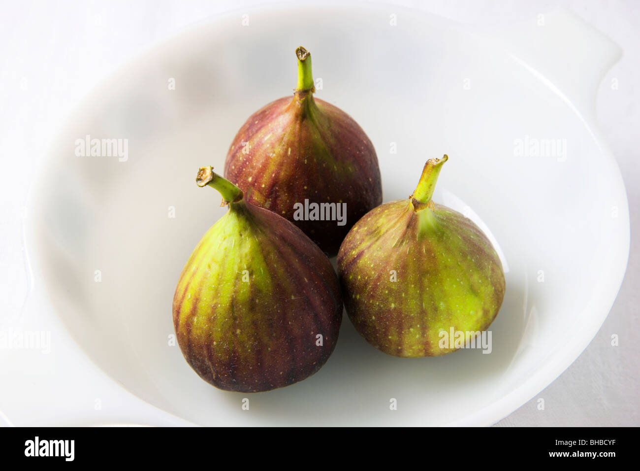 Three Fresh Figs in a White Bowl Stock Photo - Alamy