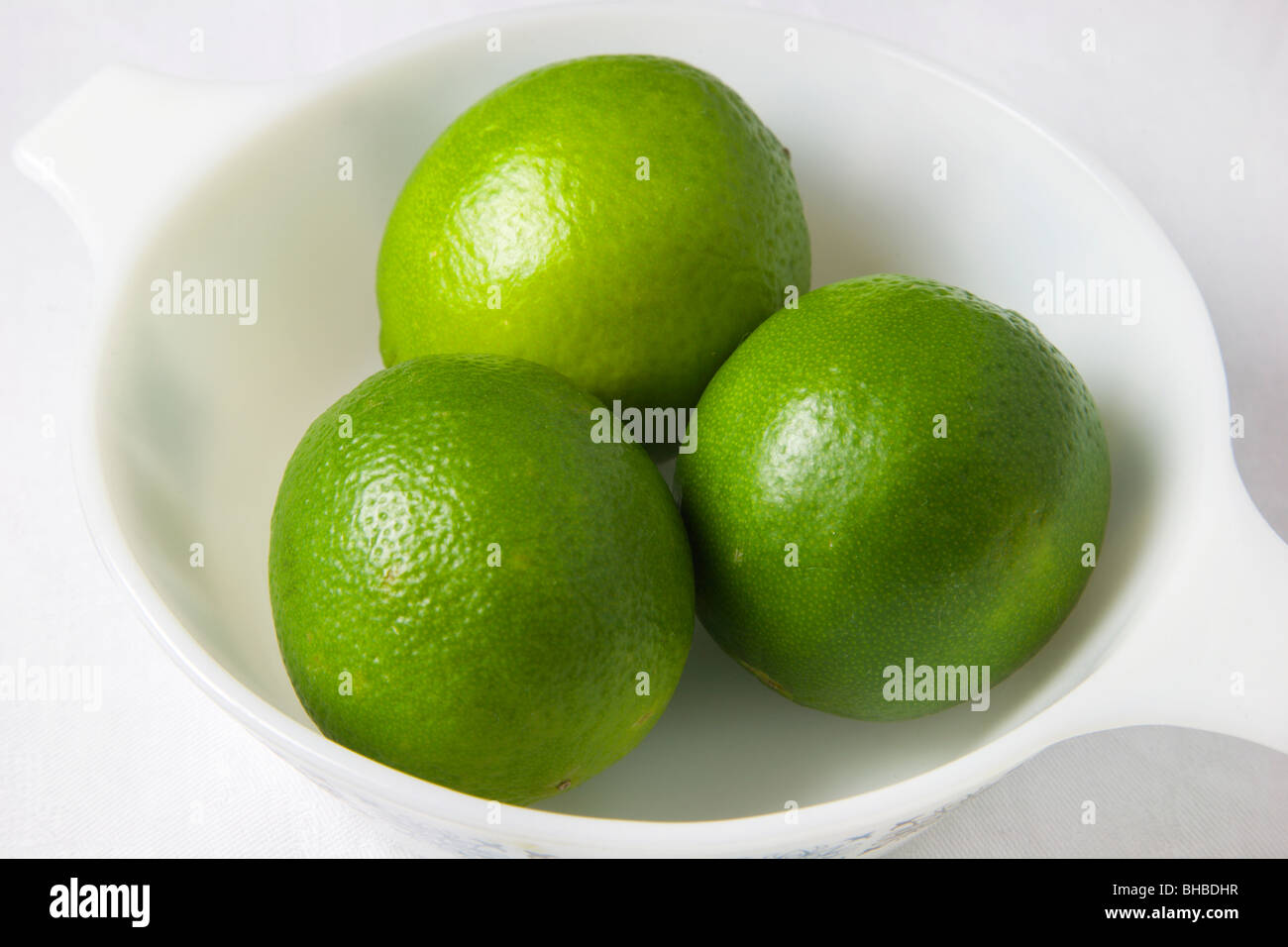 Three limes in a white dish hi-res stock photography and images - Alamy