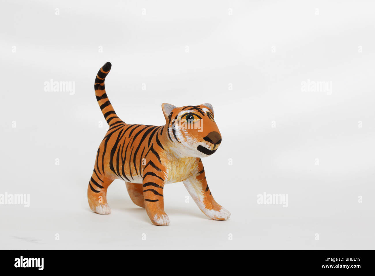Tiger figurine on white background Stock Photo - Alamy