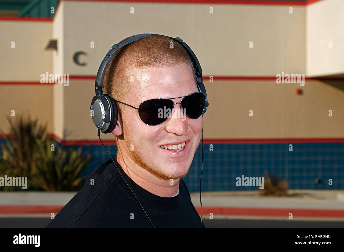 A trendy young man listen to his music on headphones Stock Photo - Alamy