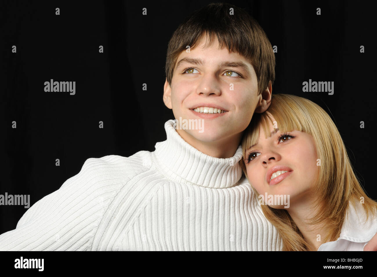 Young enamoured pair. A romantic atmosphere. A dark back Stock Photo ...