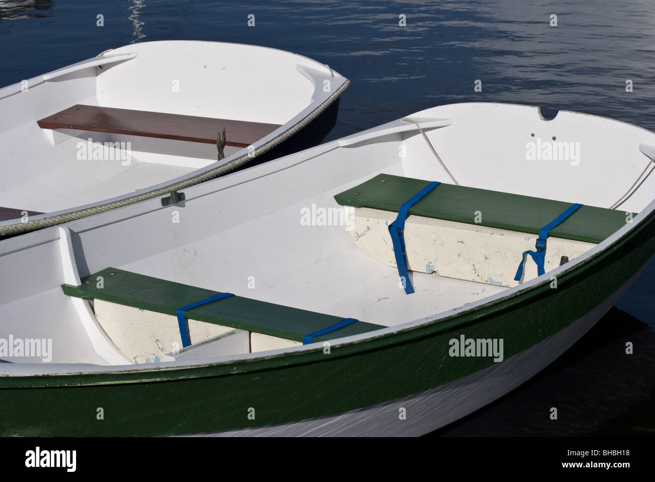 Two small boats float in the calm waters of a New England marina Stock ...