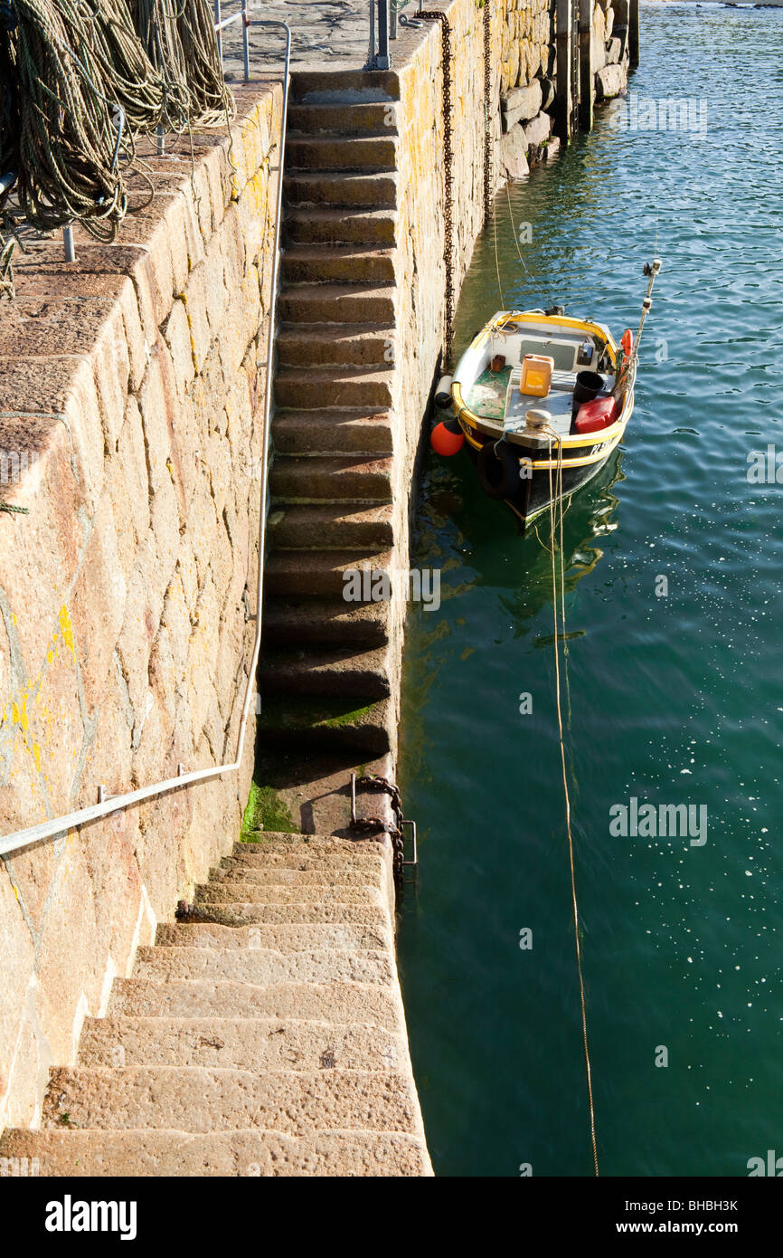 Evening sunlight falling on the harbour steps at Mousehole, Cornwall ...