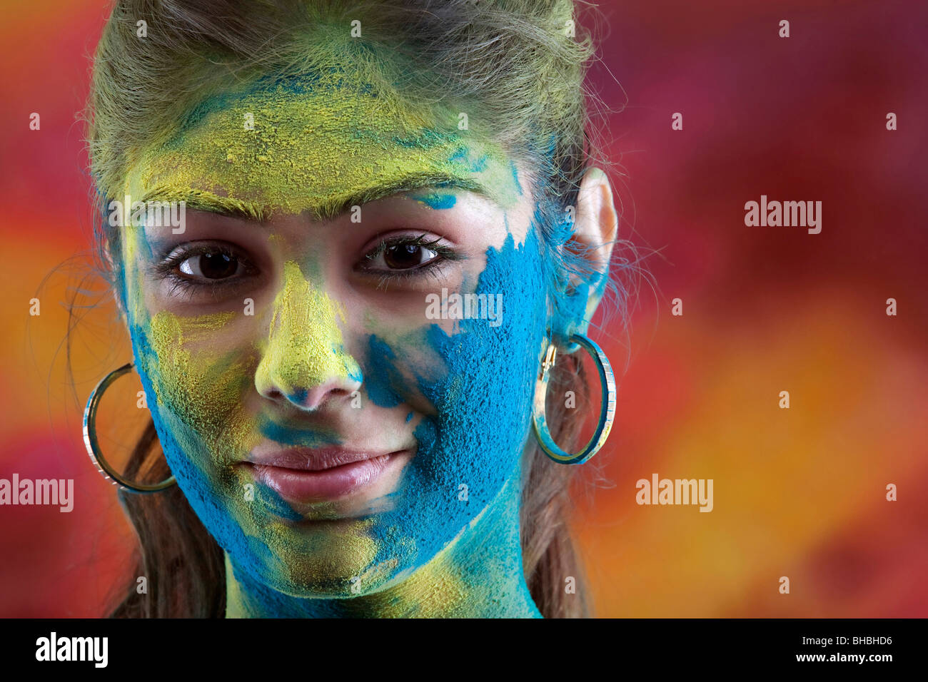 Woman's face covered in holi colours Stock Photo - Alamy