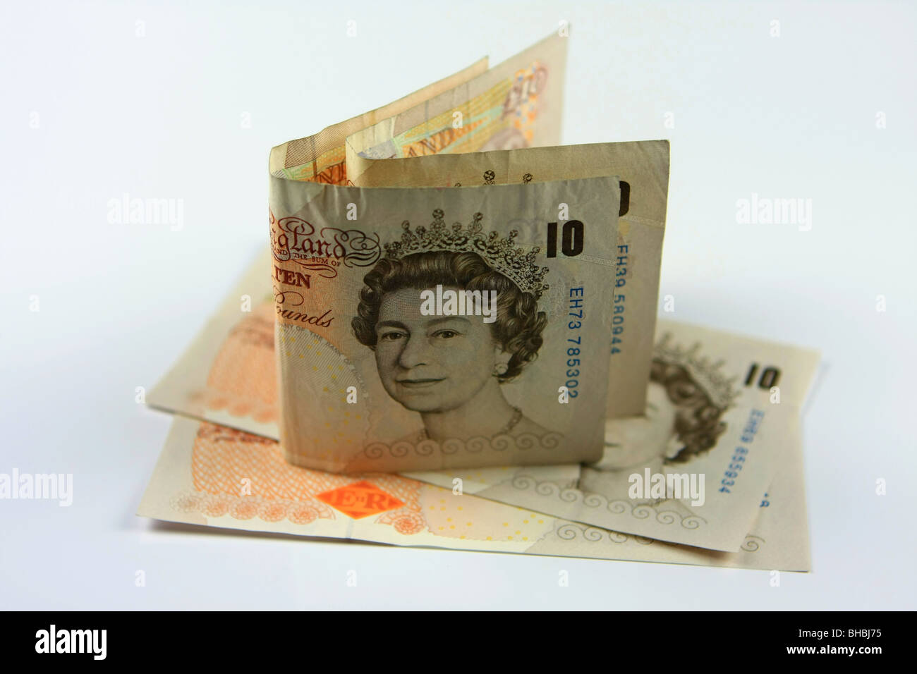 two folded £10 notes standing upright on two flat £10 notes Stock Photo ...