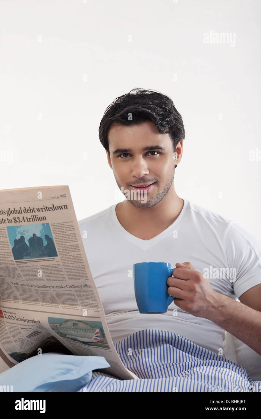 Man with a newspaper and coffee Stock Photo - Alamy
