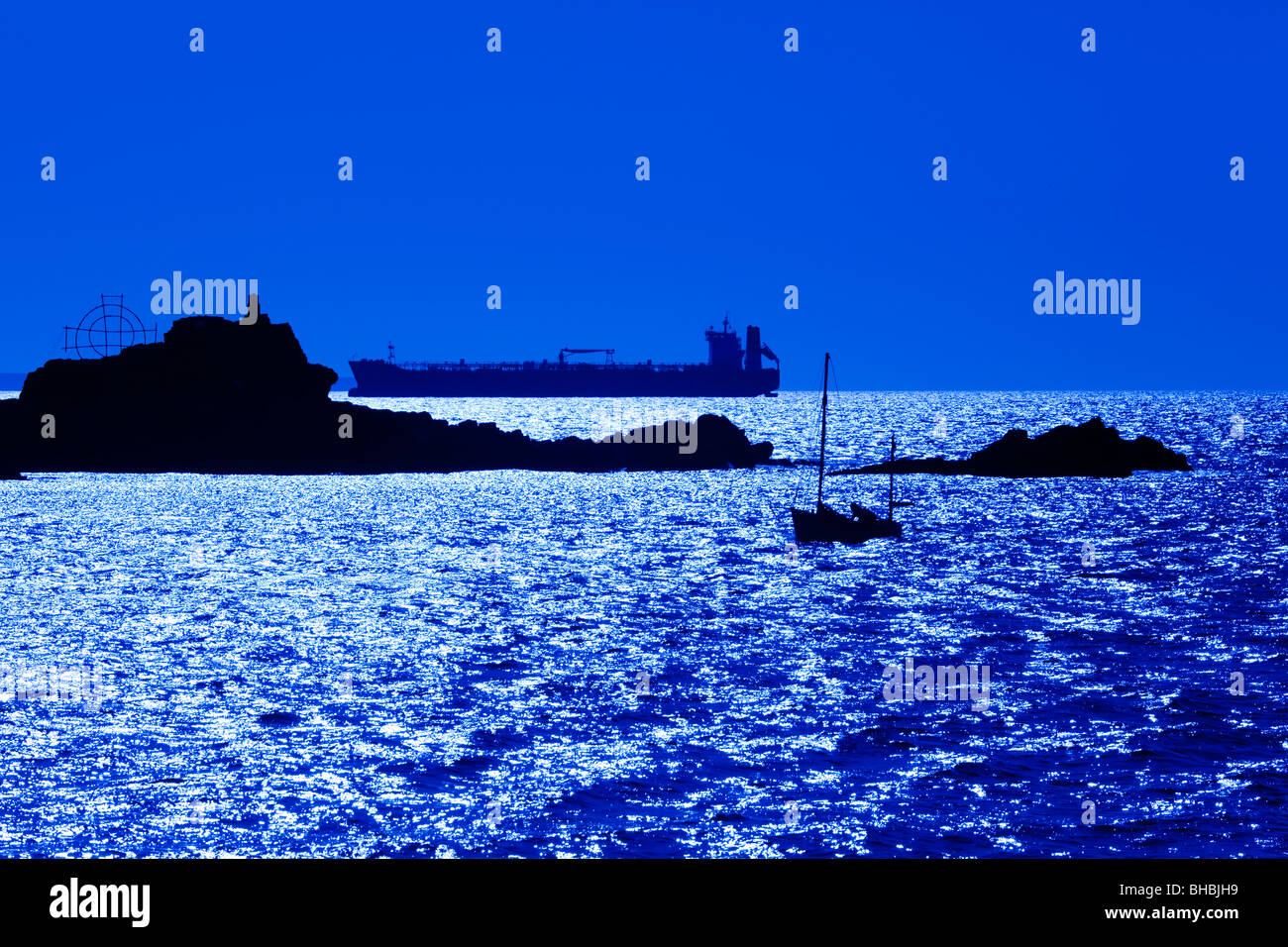 A sailing boat is about to enter the harbour at Mousehole, Cornwall UK ...
