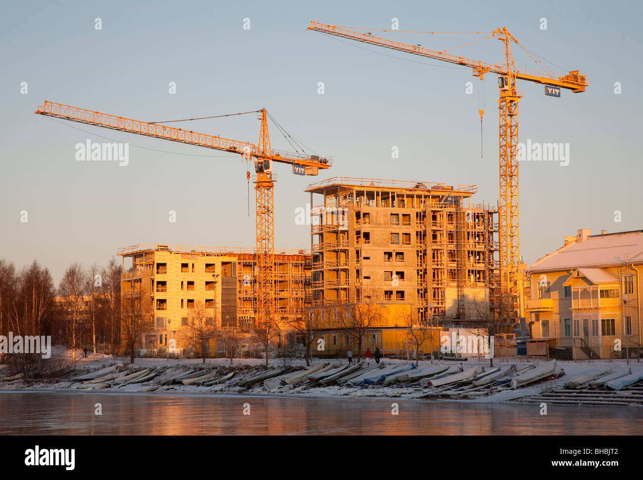 Finnish construction site and cranes at the riverbank of the Oulujoki ...