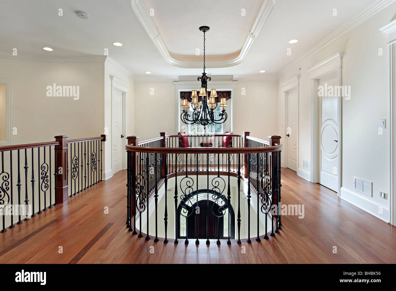 Second floor landing with wood and brass railing Stock Photo - Alamy