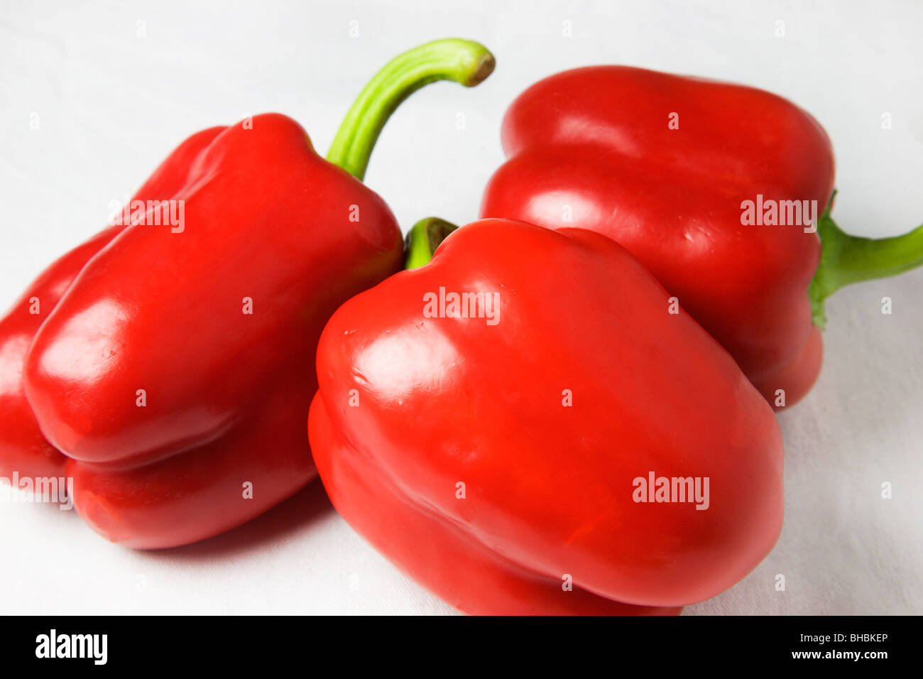 Three Red Peppers on a White Background Stock Photo - Alamy