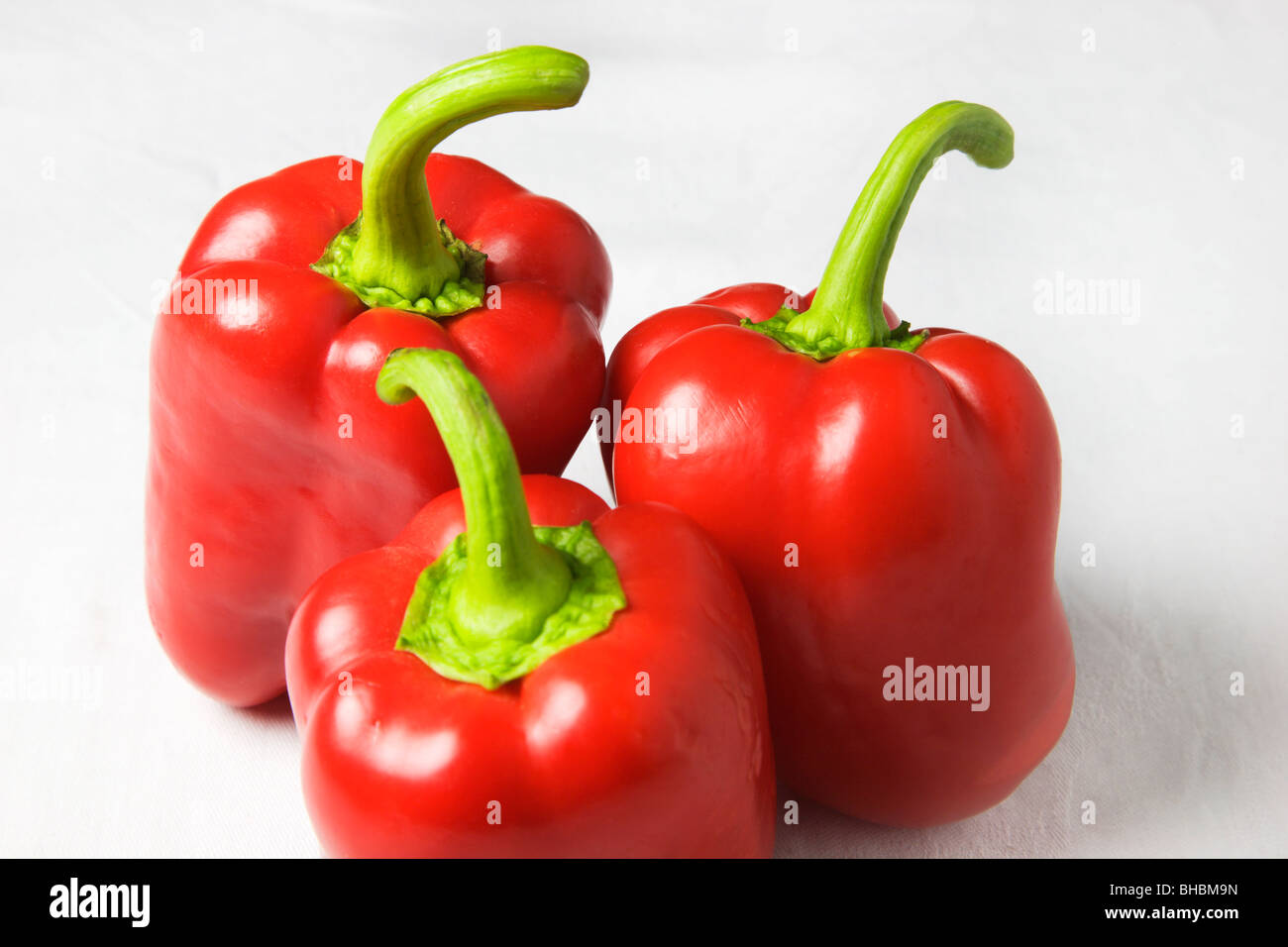 Three Red Peppers on a White Background Stock Photo - Alamy