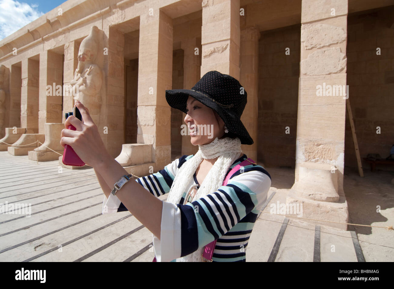 Pretty Japanese tourist takes a photograph at Hatshetsup Temple, Luxor ...