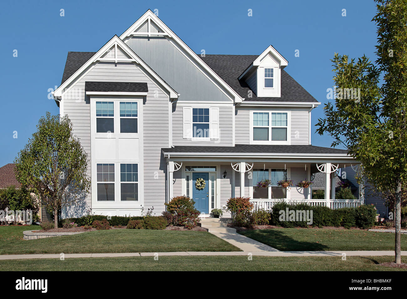 Suburban home with front porch and blue door Stock Photo - Alamy