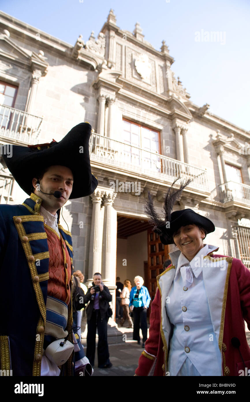 Tour guides wearing eighteenth century costumes guide a group through ...