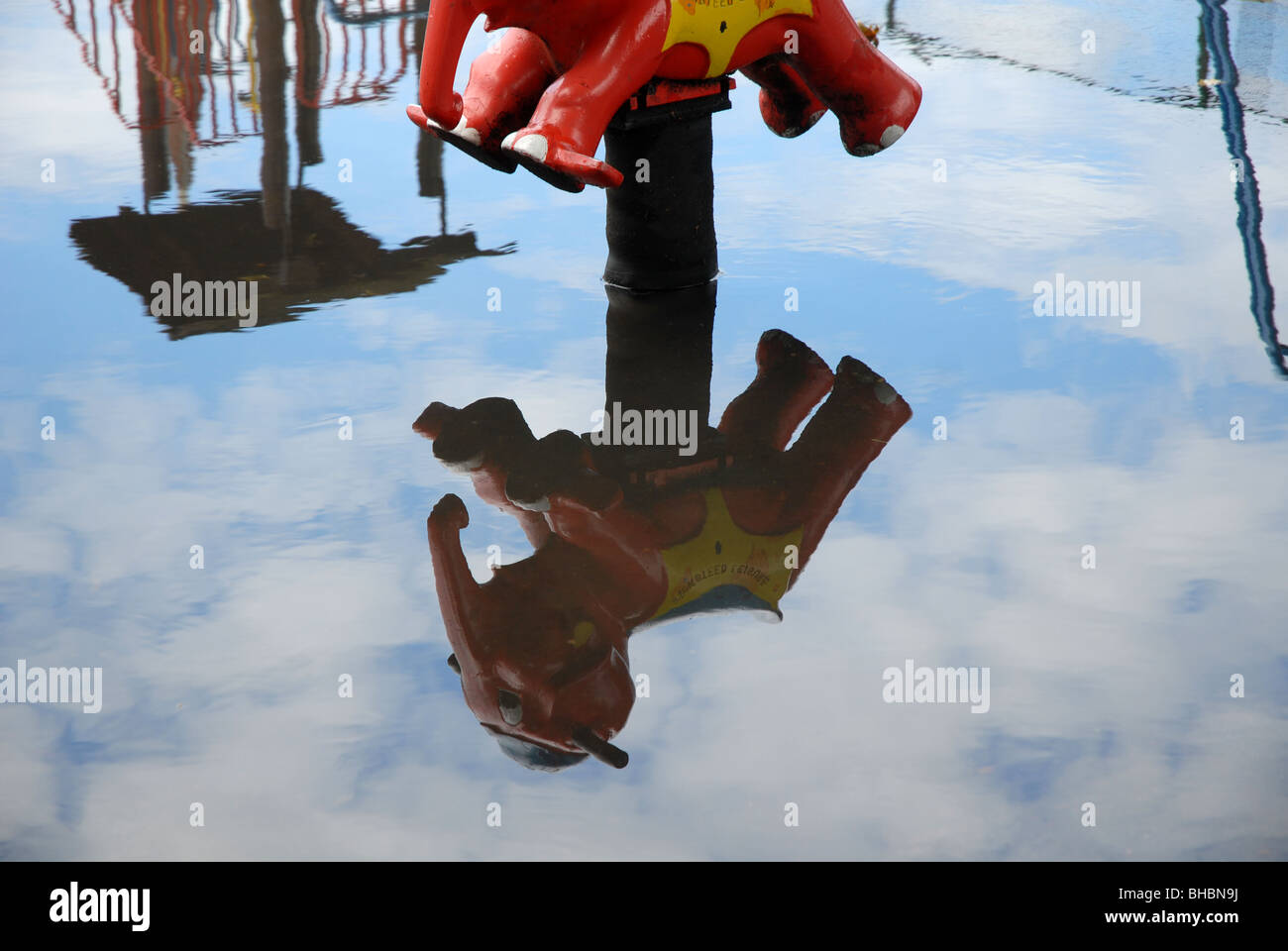 Flooded playground with reflections of children's rides Stock Photo - Alamy
