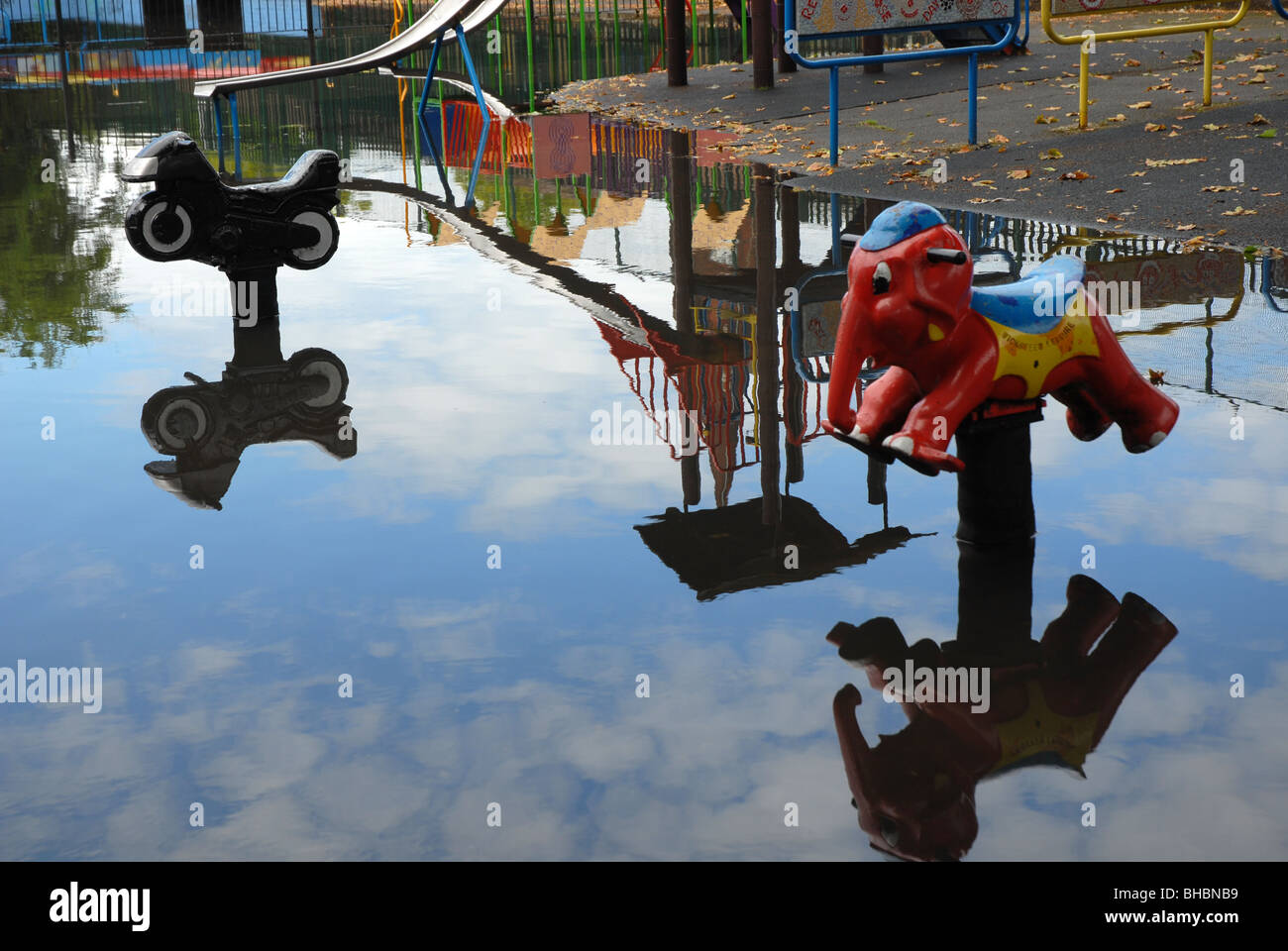 Children's playground flooded due to heavy rain with reflections of ...