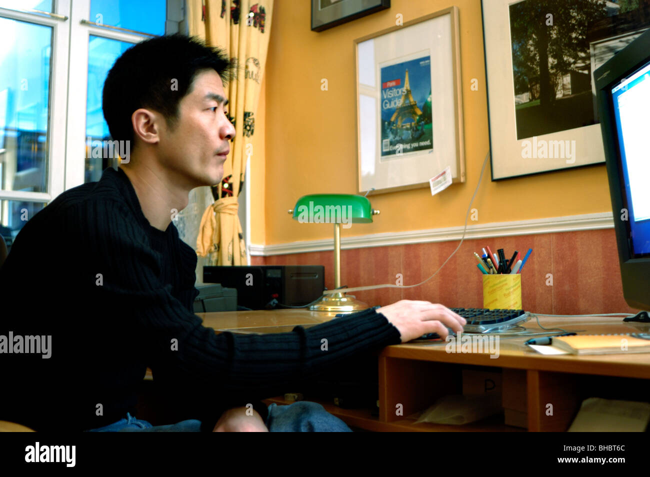 Portrait young Asian Student Using home Looking at Computer Screen at ...