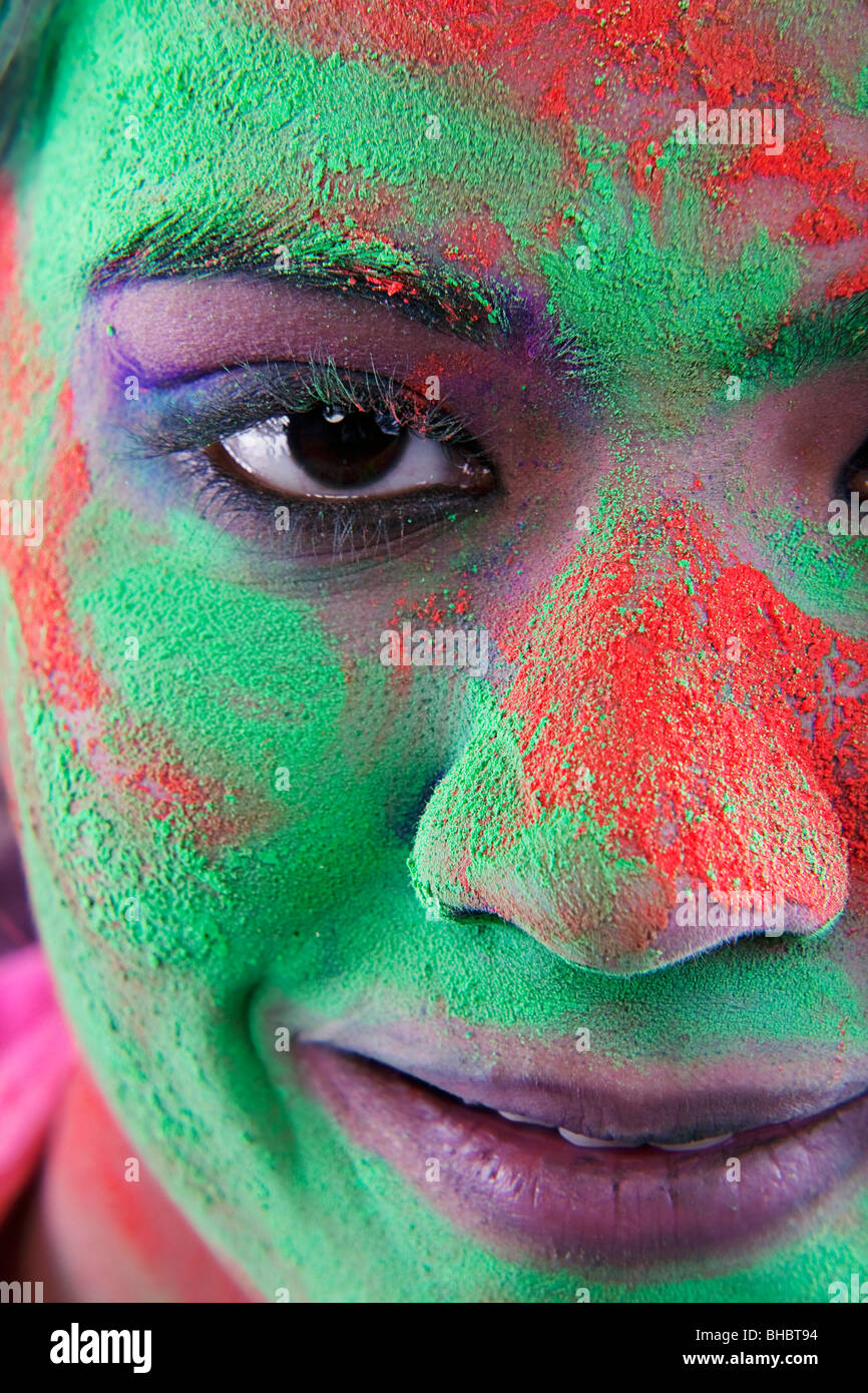 Woman's face covered in holi colours Stock Photo - Alamy