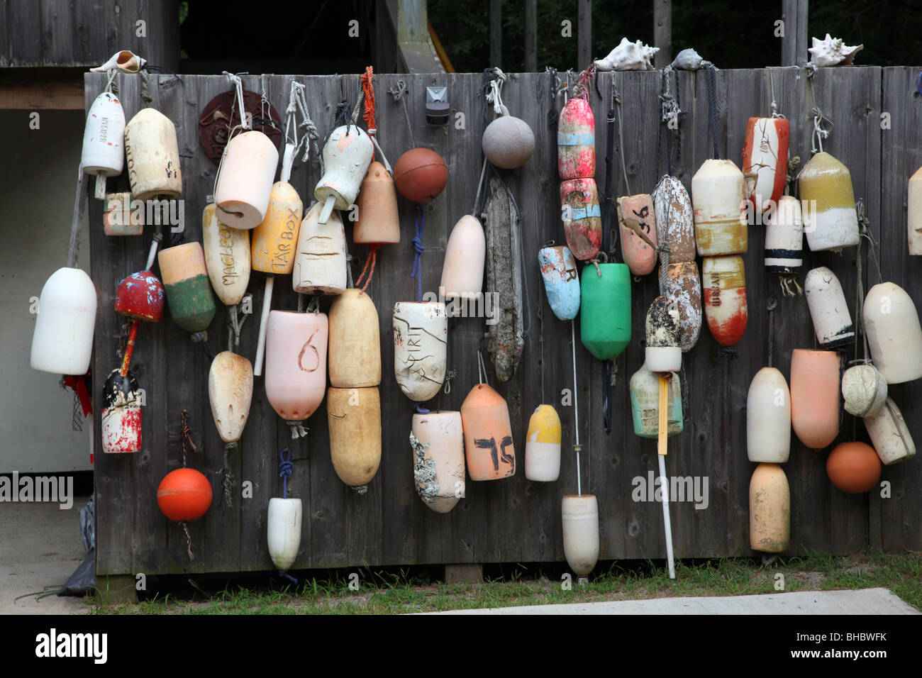 Wooden fence decorated with a variety of colorful nautical floats Stock ...