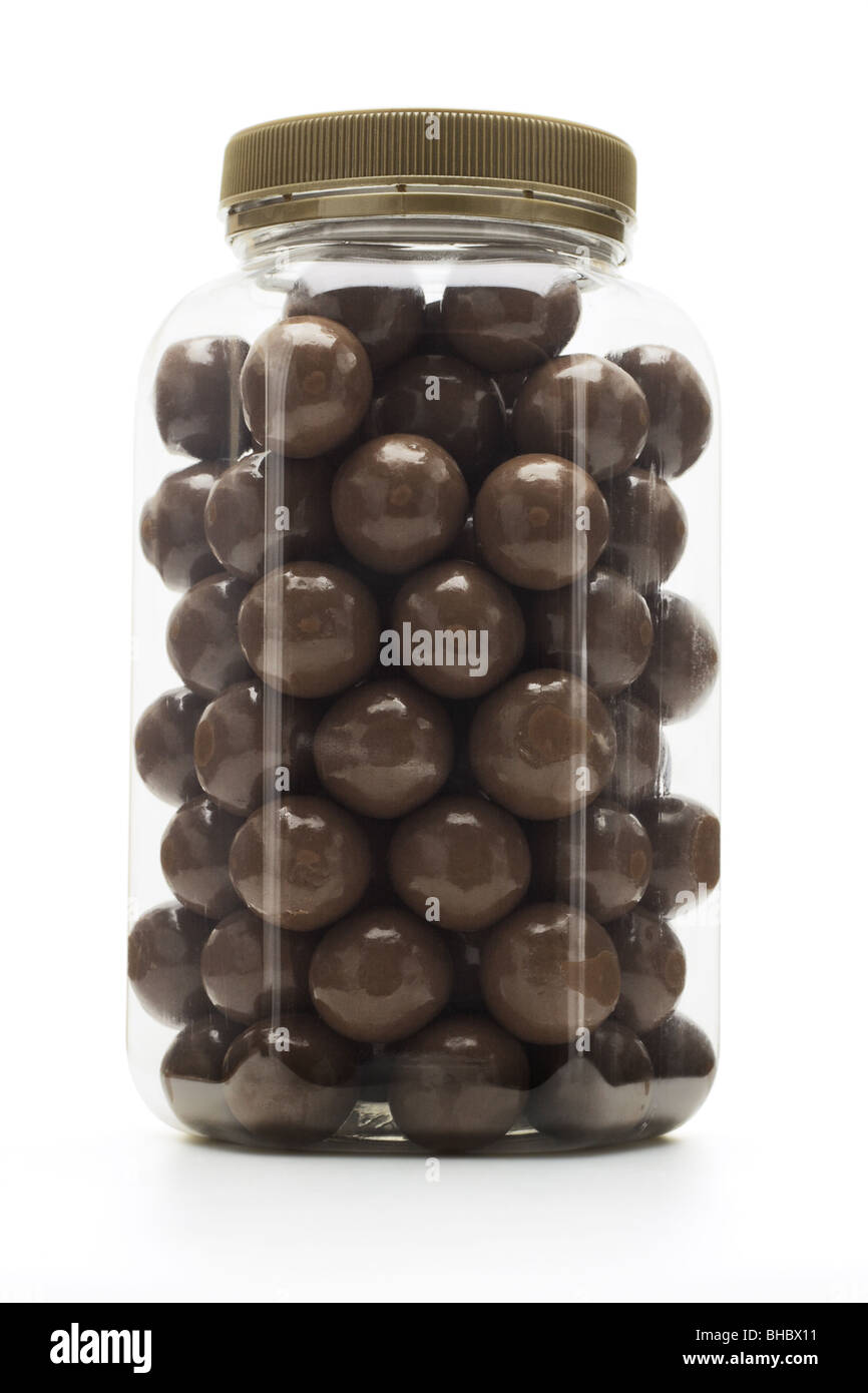 Milk chocolate coated nuts in plastic container Stock Photo - Alamy