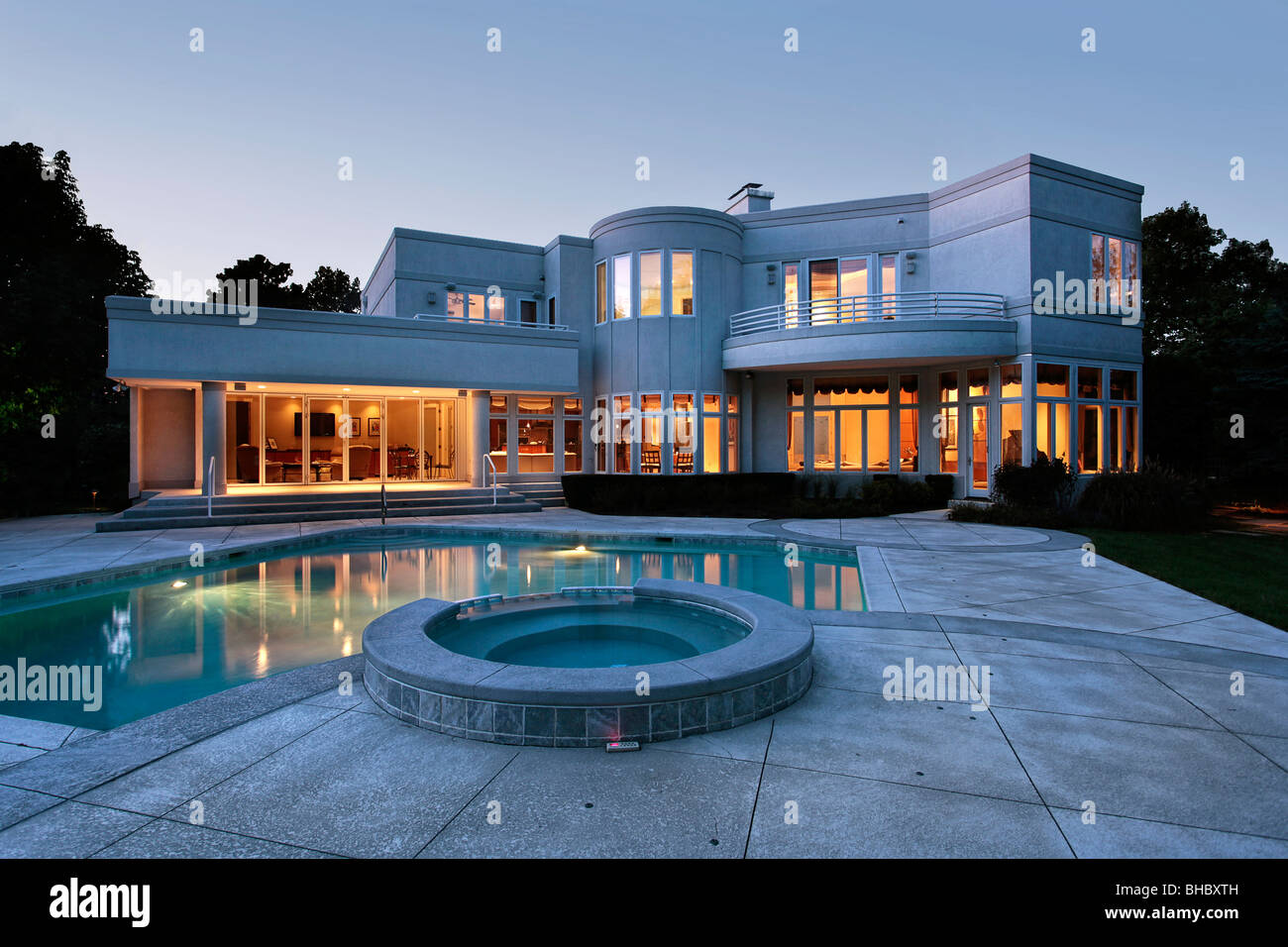 Upscale home at dusk with swimming pool Stock Photo - Alamy
