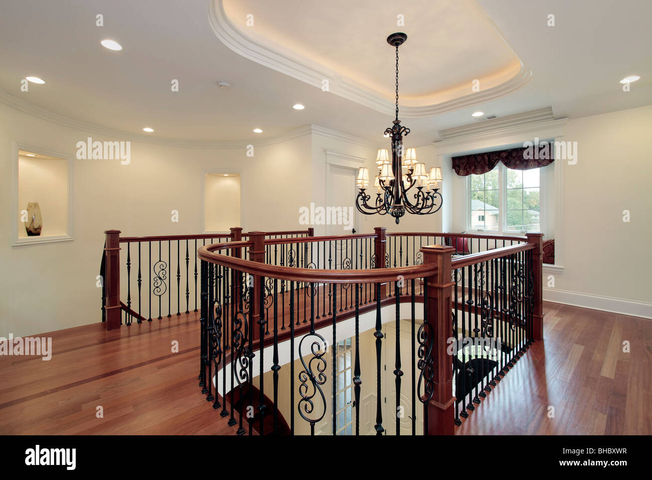 Second floor landing with wood and brass railing Stock Photo - Alamy