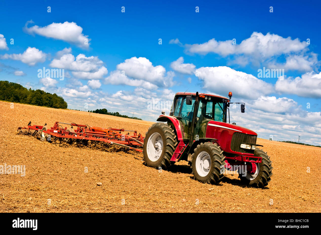 Small scale farming with tractor and plow in field Stock Photo - Alamy