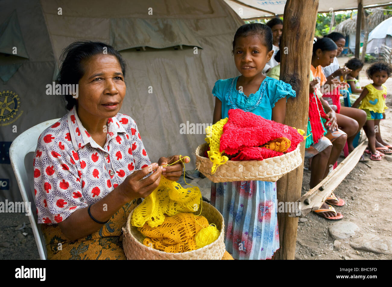 Impoverished village women at an organised community crotchet class to ...