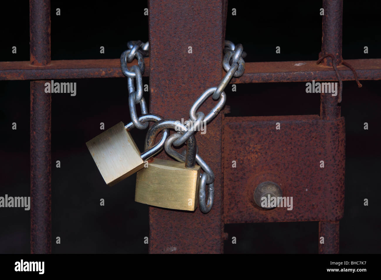 Locks and chain on a rusty gate Stock Photo - Alamy