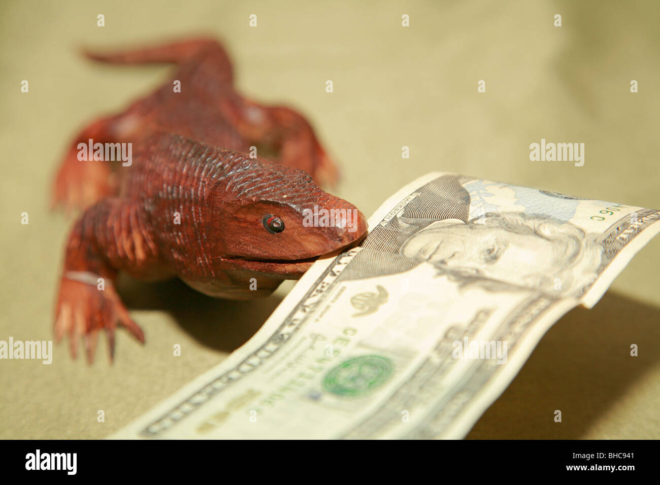 Wooden komodo dragon lizard souvenir carving biting US 20 dollar bill ...