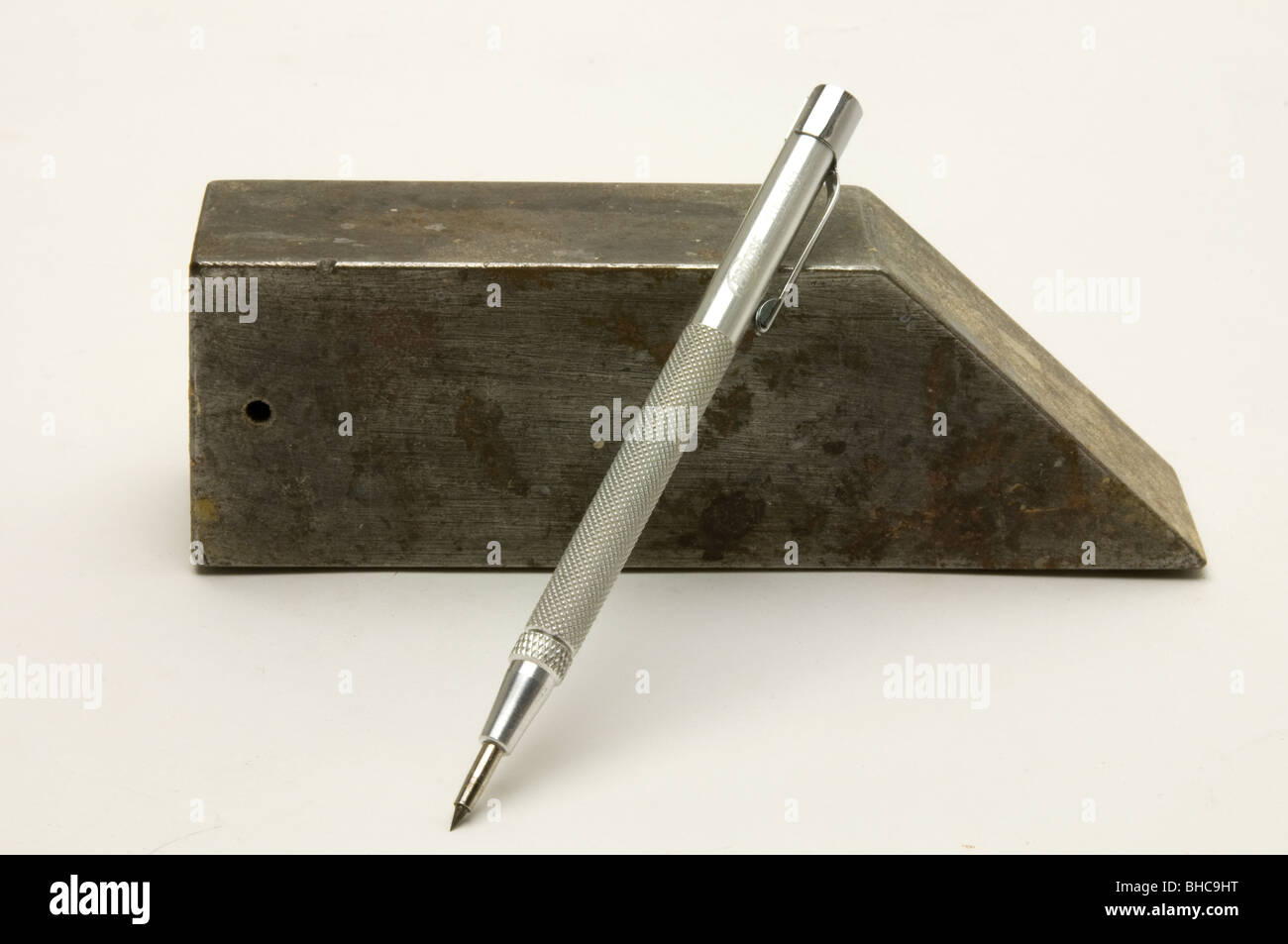 Metal scriber and steel block in isolation on a white background Stock ...