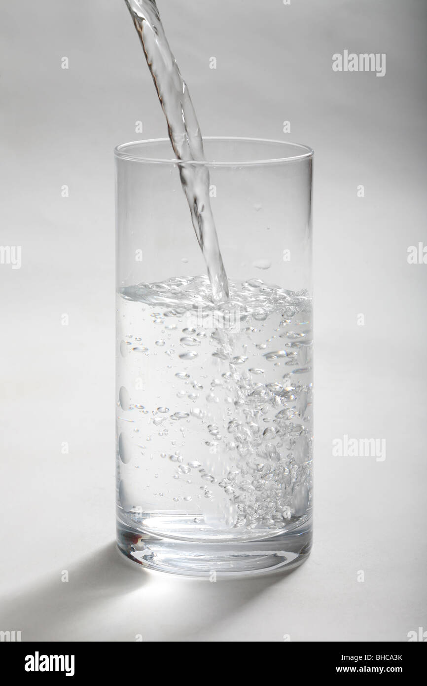 Water being poured into a glass Stock Photo - Alamy